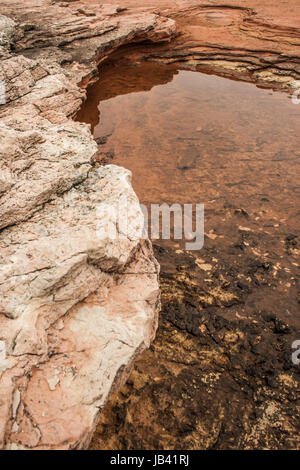 View of different colored rock layers in a river bed Stock Photo - Alamy