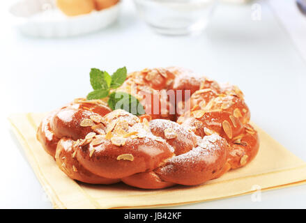 Sweet braided bread sprinkled with icing sugar Stock Photo - Alamy