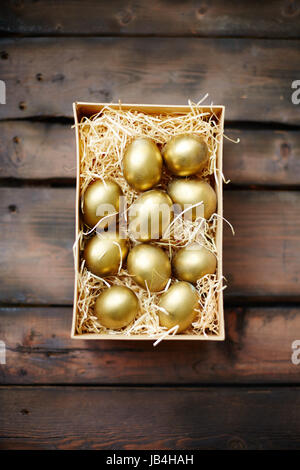 Golden Easter eggs in rectangular box Stock Photo - Alamy