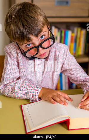 little nerdy boy with geeky goggles thinking real hard Stock Photo - Alamy