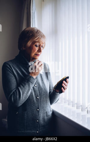 Woman with tears on her face holding portrait of the fallen soldier at ...