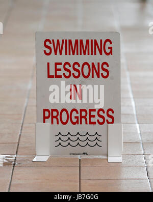 Swimming Lesson In Progress sign by the side of a swimming Pool Stock ...