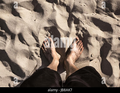 Photograph of a pair of feet on beach sand Stock Photo - Alamy