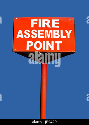 Red emergency assembly point sign with a bird on it Stock Photo - Alamy