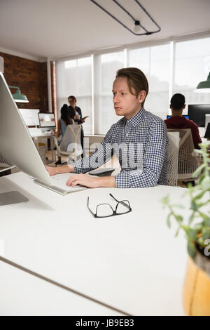 Attentive male executive working on computer in office Stock Photo - Alamy