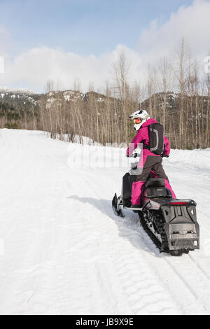 Woman riding snowmobile in snowy alps during winter Stock Photo - Alamy