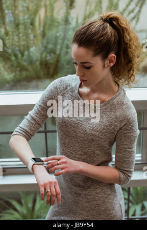 Female executive using smartwatch Stock Photo - Alamy