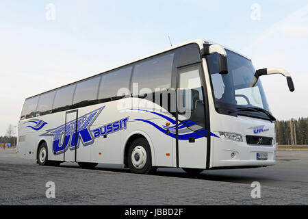 Blue coach bus waits for passengers at a bus lane on a day of spring ...
