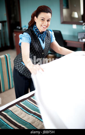 Charming hotel hostess changing the sheets, at work Stock Photo - Alamy