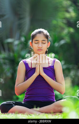 Young woman with hands in namaskar mudra Stock Photo - Alamy