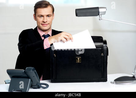 Male executive keeping documents safely in his briefcase Stock Photo ...
