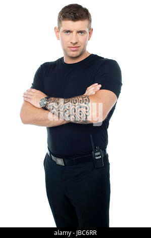 Tough serious bouncer or bodyguard with crossed arms staring at camera ...