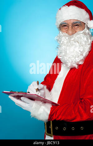 Santa Claus making list of gifts on white background Stock Photo - Alamy