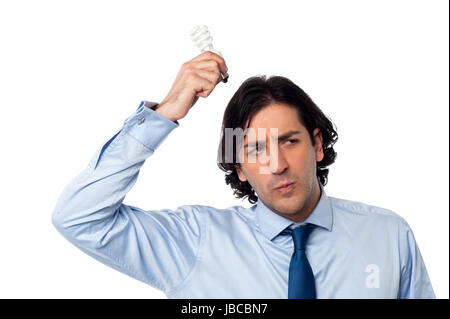 Confused male executive unsure of his new bright idea Stock Photo - Alamy