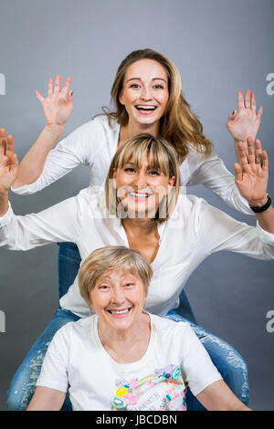 drei generationen großmutter mutter und tochter im portrait vor grauem ...