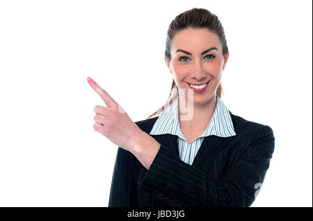 Lady pointing towards copy space area Stock Photo - Alamy