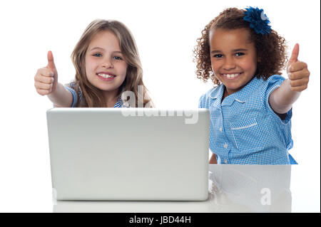 School kids with laptop gesturing thumbs up Stock Photo - Alamy