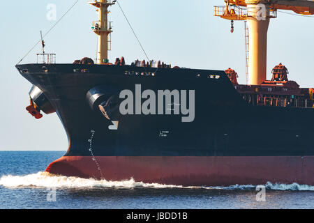 Black cargo ship sailing from the Baltic sea Stock Photo - Alamy