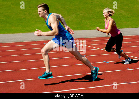 Young lady sprinting and running to the finish line in a cross country ...