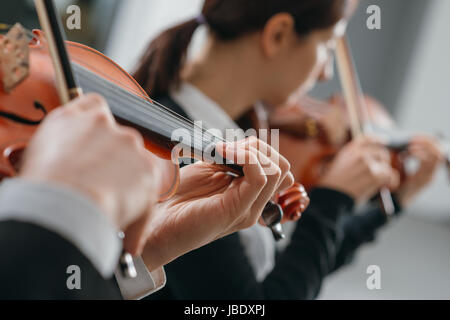 Two violinists performing together hands close up, classical music ...