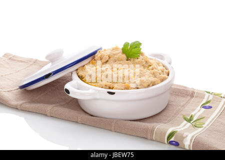 Delicious hummus in ceramic pot on white and blue table cloth isolated ...