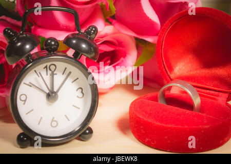 Wedding ring, alarm clock Tell time in life Stock Photo - Alamy