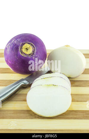 Three purple turnips Brassica rapa are positioned on a white background ...