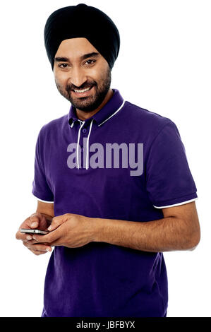 Young indian guy sending text message Stock Photo - Alamy
