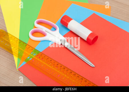 Paper with ruler glue and scissors on a wooden table, close-up Stock ...