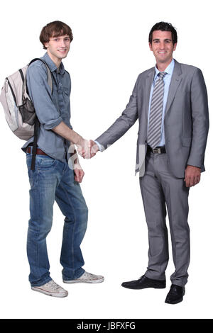 Boy shaking teachers hand Stock Photo - Alamy