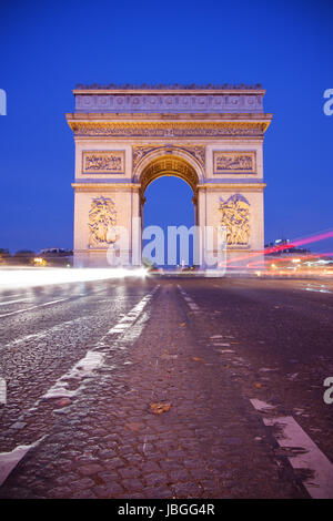 A vertical shot of the Arc de Triomphe in Paris wrapped in silvery blue ...