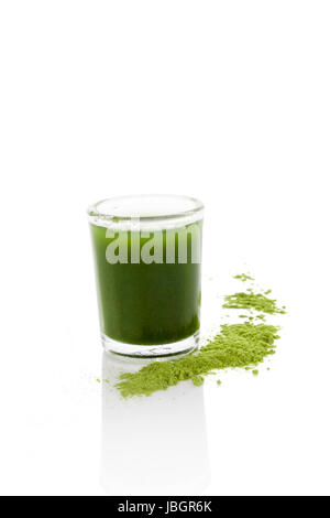 A vertical shot of a wheatgrass juice isolated on white background ...