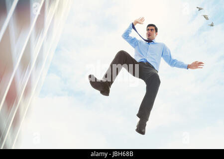 Stock image of businessman falling off a building Stock Photo - Alamy