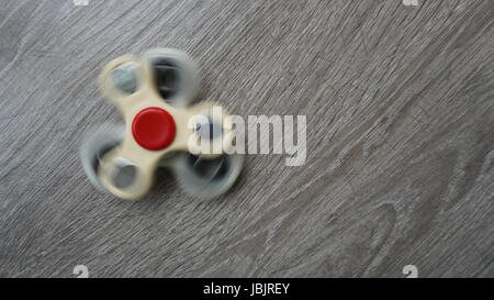 two hand spinner lying on grey laminate Stock Photo - Alamy