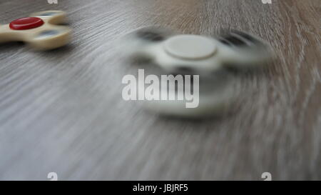 two hand spinner lying on grey laminate Stock Photo - Alamy