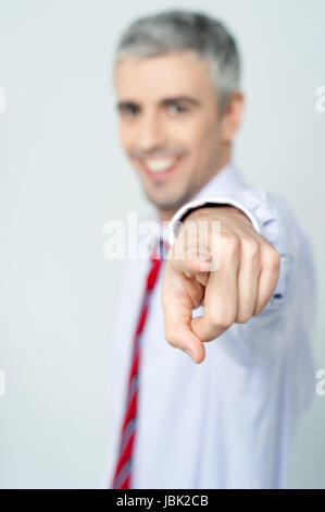 Young businessman pointing finger at viewer Stock Photo - Alamy