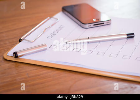 Checklist concept - checklist, paper and a pen with checklist word on ...