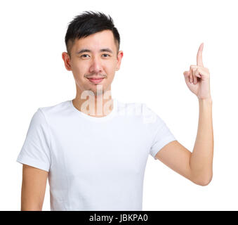 Cheerful attractive korean guy pointing finger at mobile phone screen ...