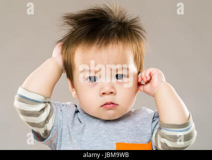 Confused baby scratching head Stock Photo - Alamy