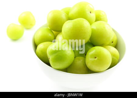 composition of fresh turkish can erik plum fruits in a small white bowl ...