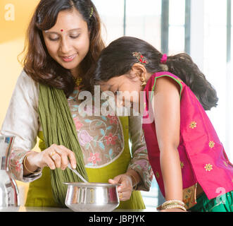 Mother and daughter preparing traditional India Roti bread. Model ...