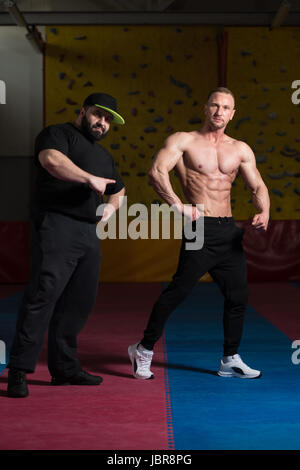 Portrait Of A Man Posing Bodybuilding Poses In Fitness Center and ...