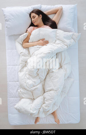 Young woman covering herself at home in morning, focus on clock Stock ...