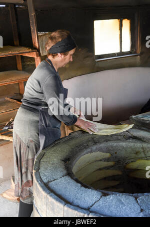 Traditional baking of Georgian Shoti bread in a tone oven. High quality ...