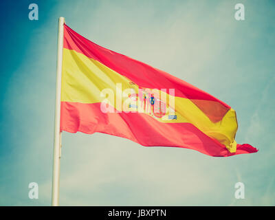 Vintage retro looking Flag of Spain over a blue sky Stock Photo - Alamy