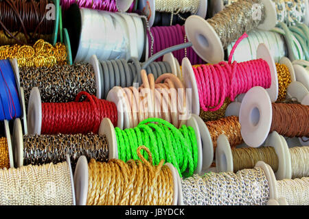 Large pile of colorful ropes on plastic spools Stock Photo - Alamy