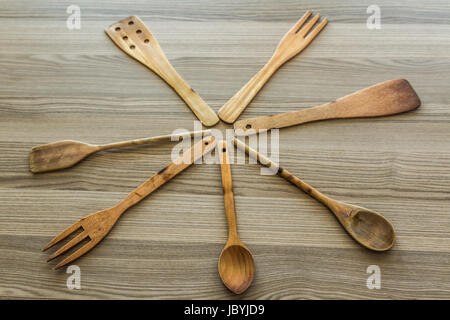 Kitchen wooden utensil of scapula, spoon and fork on wooden table Stock ...