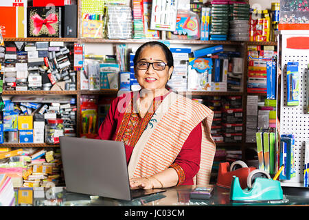 1 Indian Shop Keeper Woman Using Laptop amd Showing Thumbs up In ...