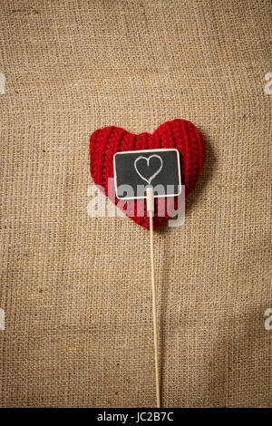 Closeup shot of a handmade card with heart-shape sticker on red ...