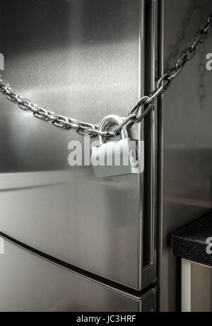 Lock on the fridge. Metal padlock hanging on the refrigerator. Concept ...
